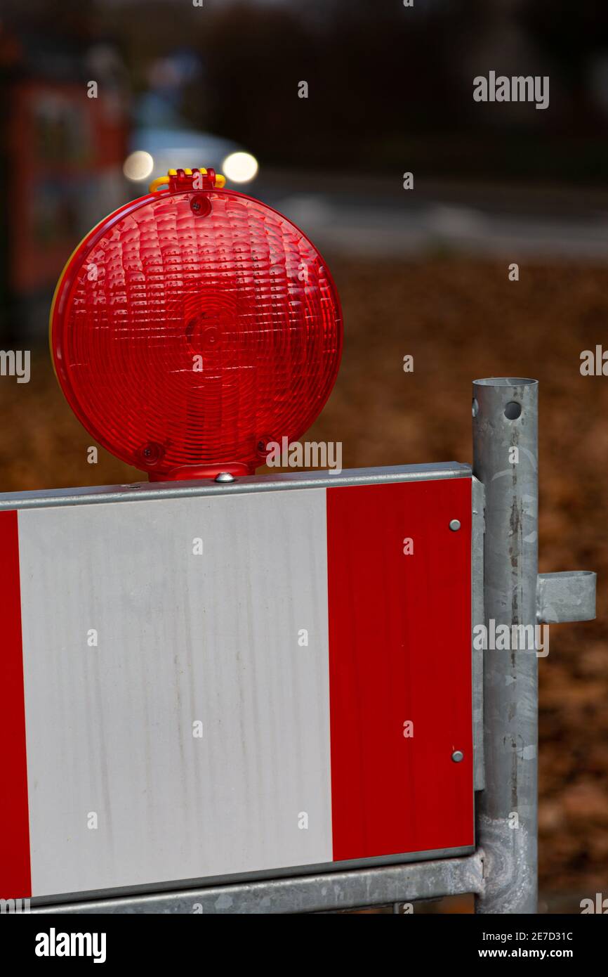 A vertical shot of red warning lights with street barriers at a ...