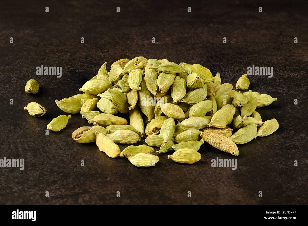 Pile of cardamom on abstract background Stock Photo - Alamy