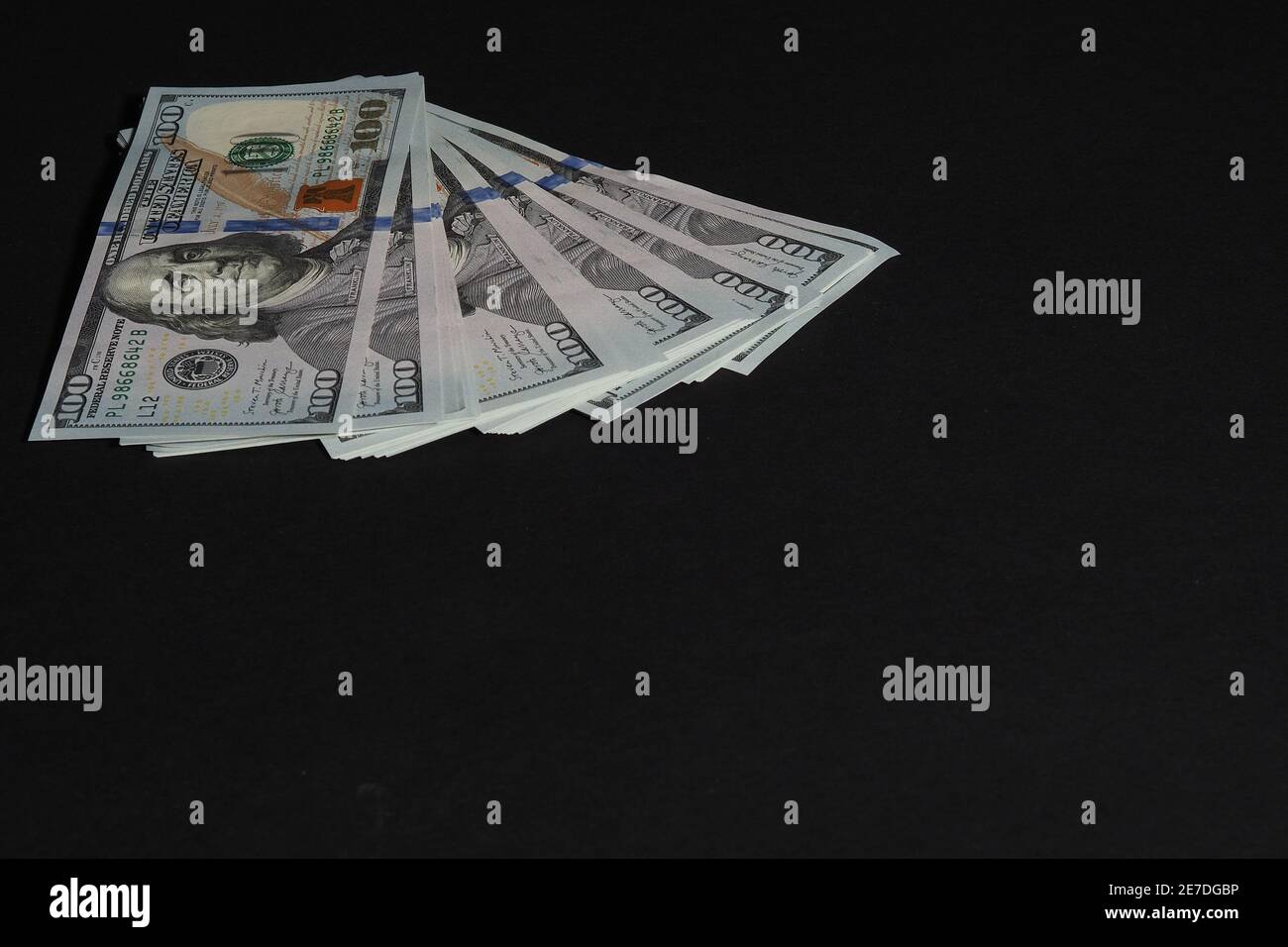 The American dollar. Paper bills of a hundred dollars on a black ...