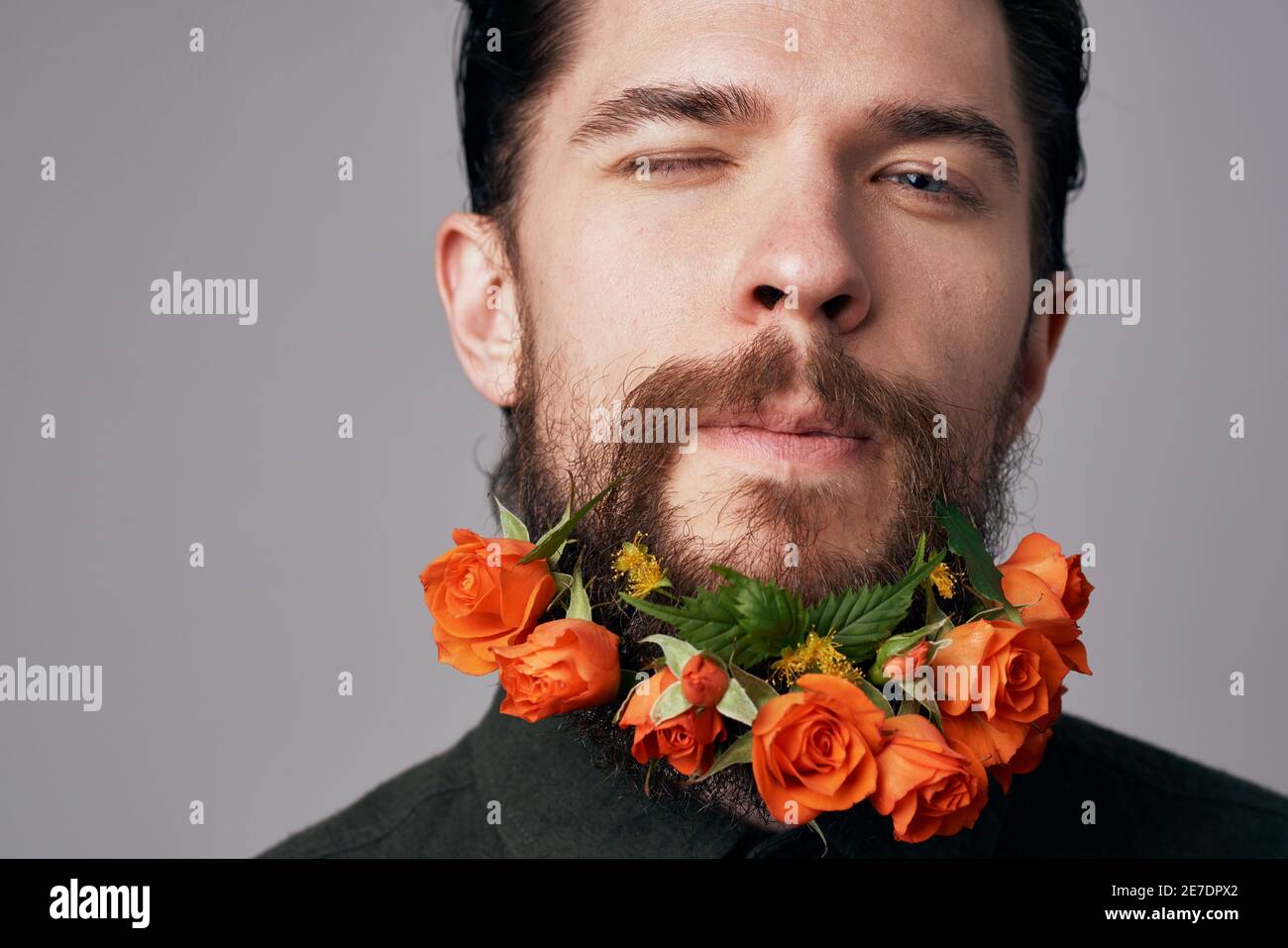 Elegant man black shirt flowers in a beard decoration romance ... Elegant man black shirt flowers in a beard decoration romance ...
