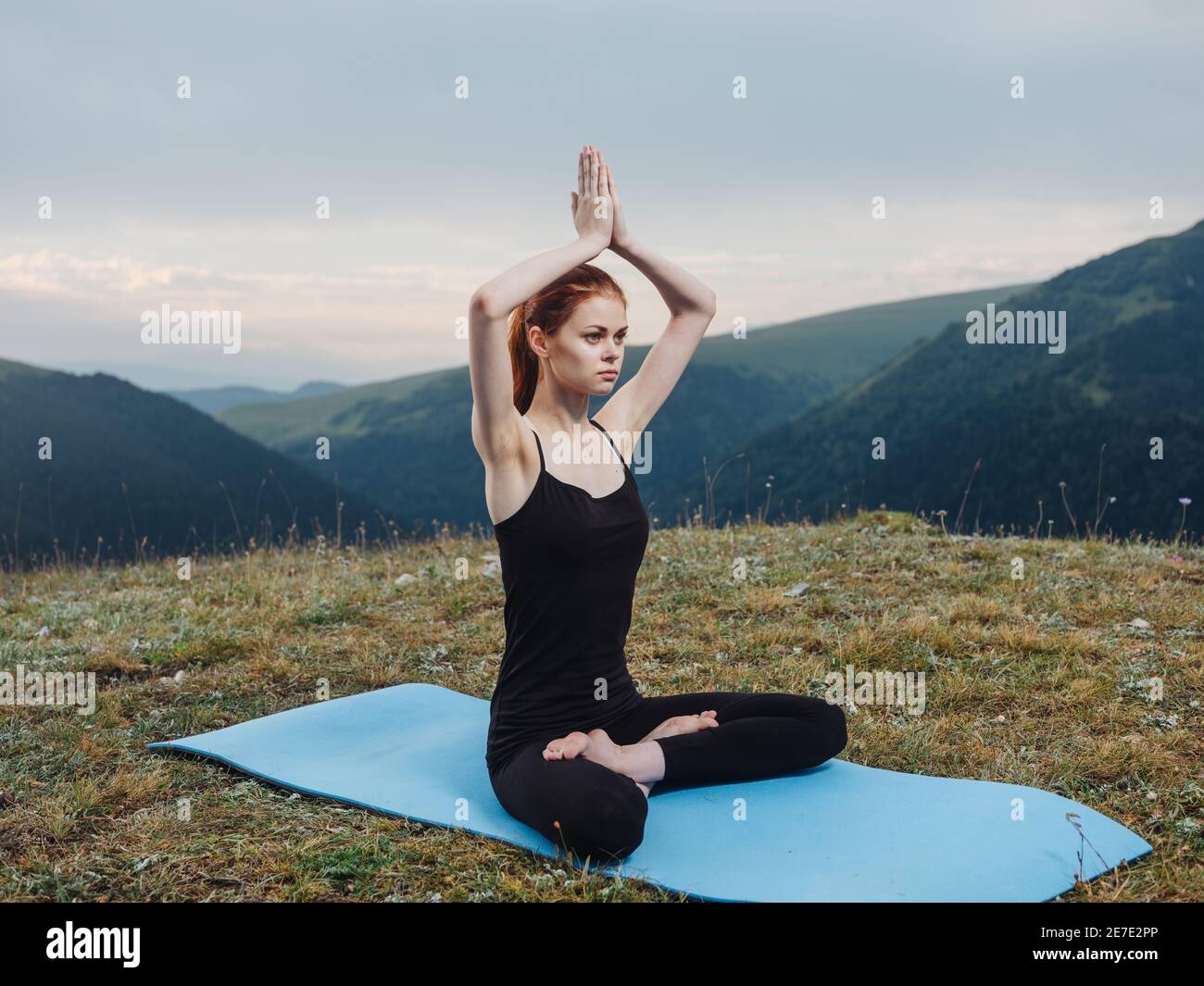 Woman sitting on a mat meditation yoga asana nature fresh air Stock ...
