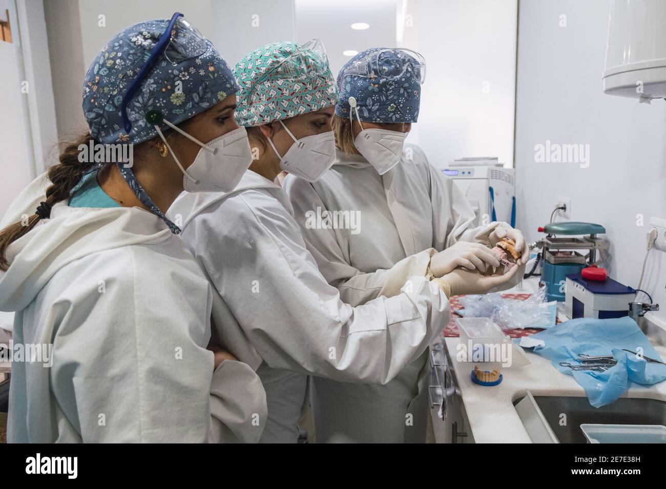 Doctors examining a dental mold. Three female doctors. Dental health ...