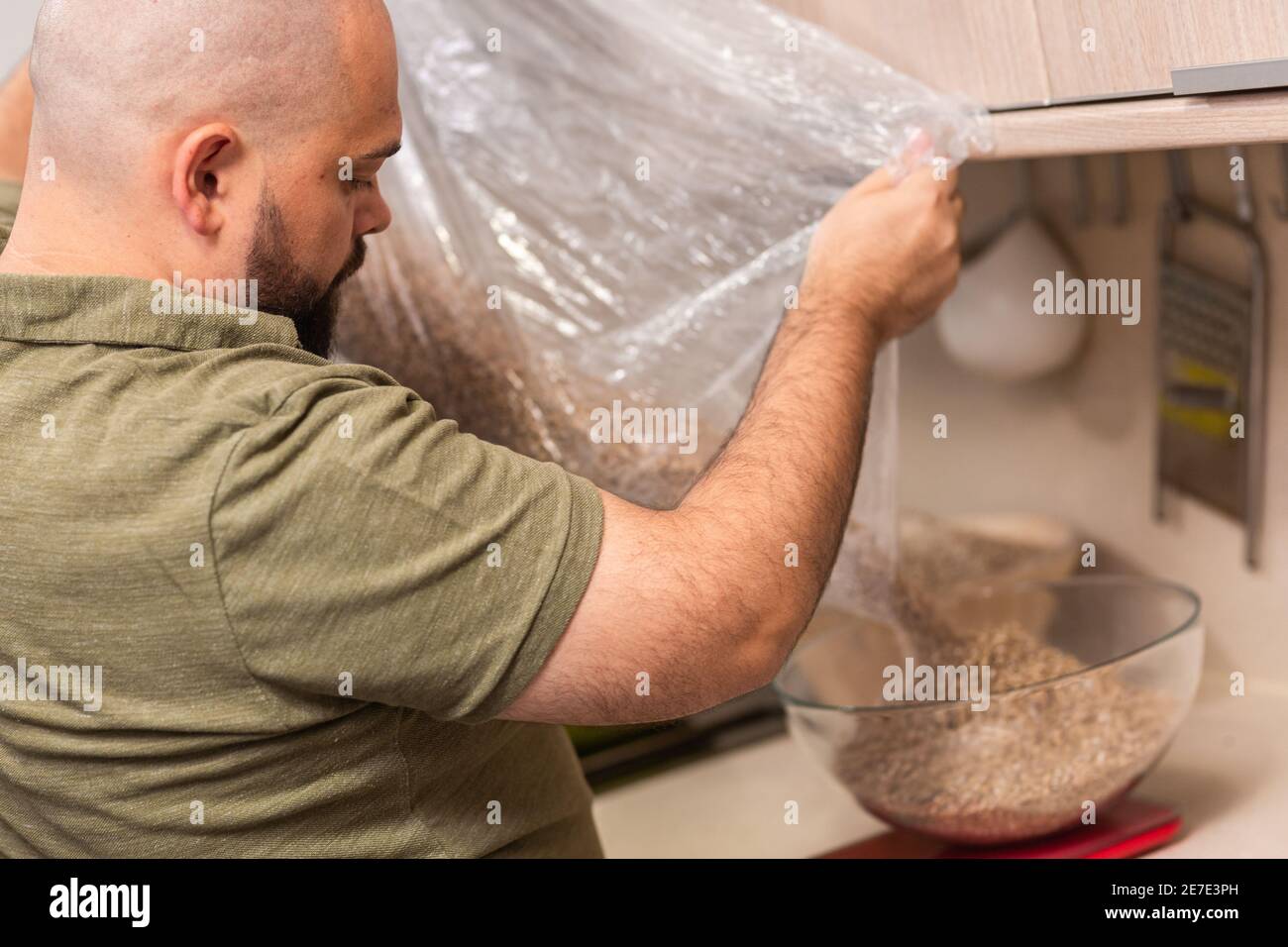 man weighs malt for brewing beer on scale Stock Photo - Alamy