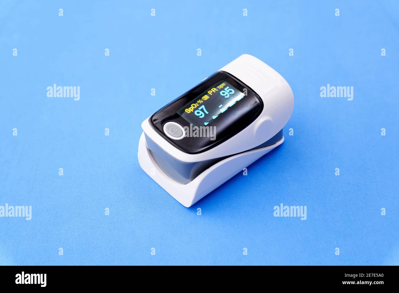 Pulse oximeter isolated a blue background Stock Photo - Alamy