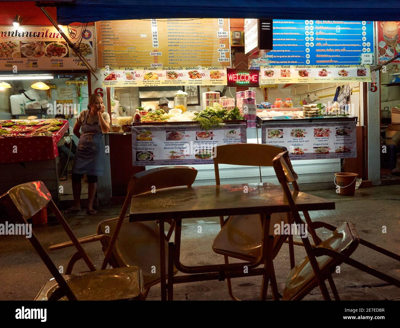 A food stall keeper is waiting for customers to stop by at his food ...