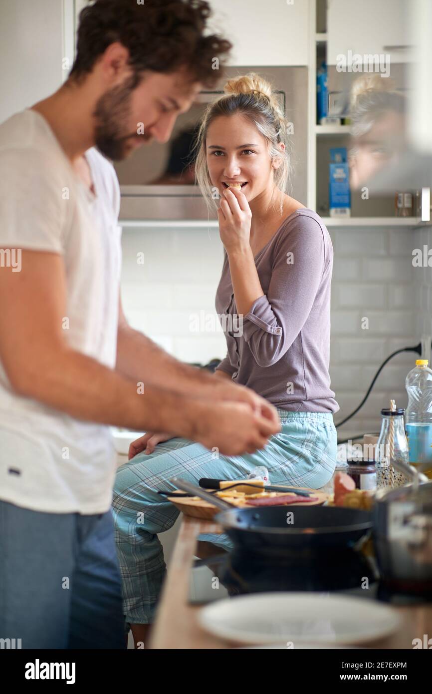 A young man in the kitchen preparing a meal for his girlfriend. Cooking ...