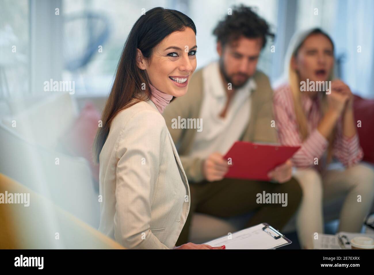 A young beautiful businesswoman enjoying for at a meeting in a friendly ...