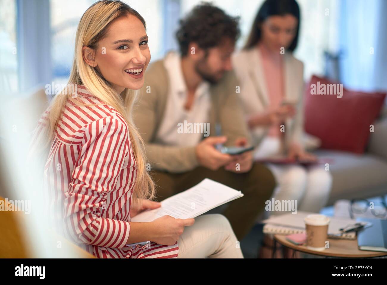 A young beautiful businesswoman enjoying and posing for a photo at a ...