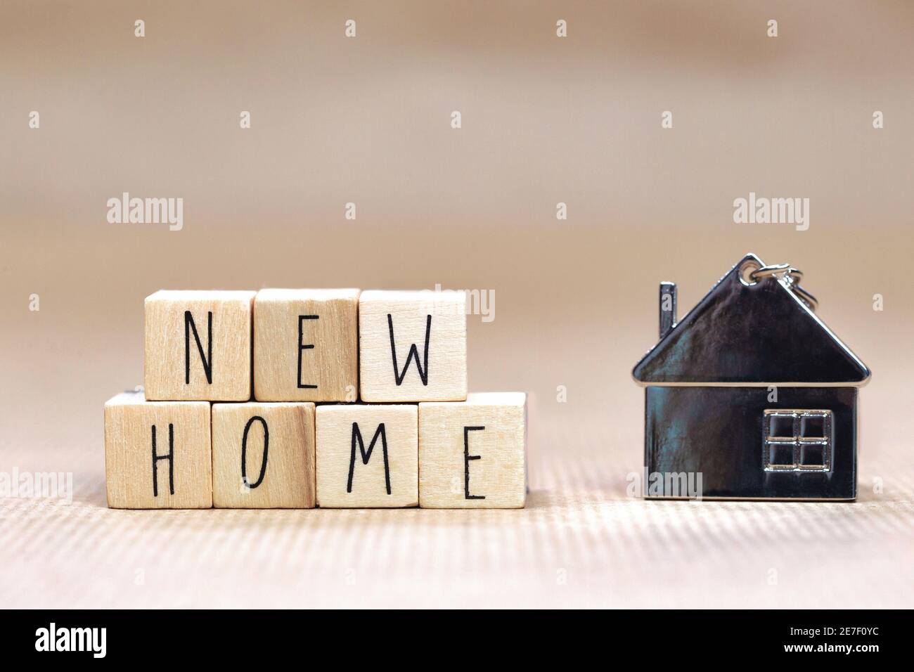 New Home text written with wooden cubes background with symbol of cozy ...