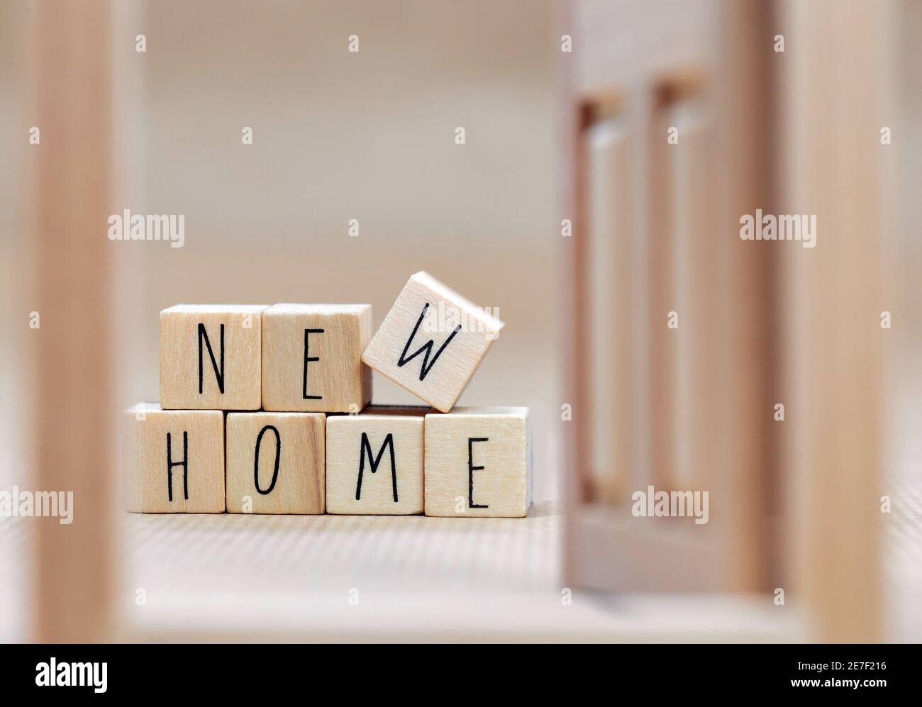 New Home text written with wooden cubes background with symbol of cozy ...