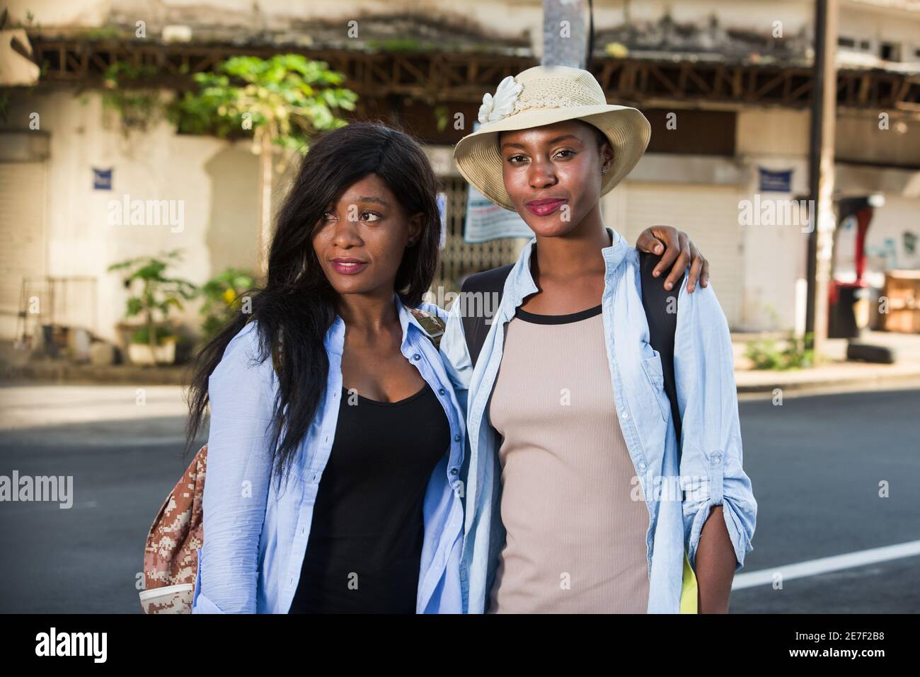 Happy tourist friends holding hands, having fun laughing together while ...