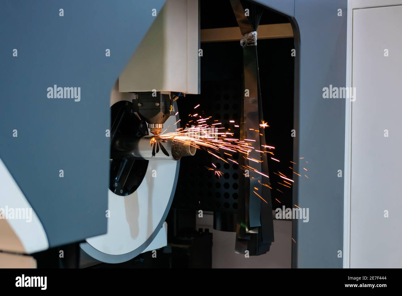 Laser cutting machine working with cylindrical metal workpiece with ...