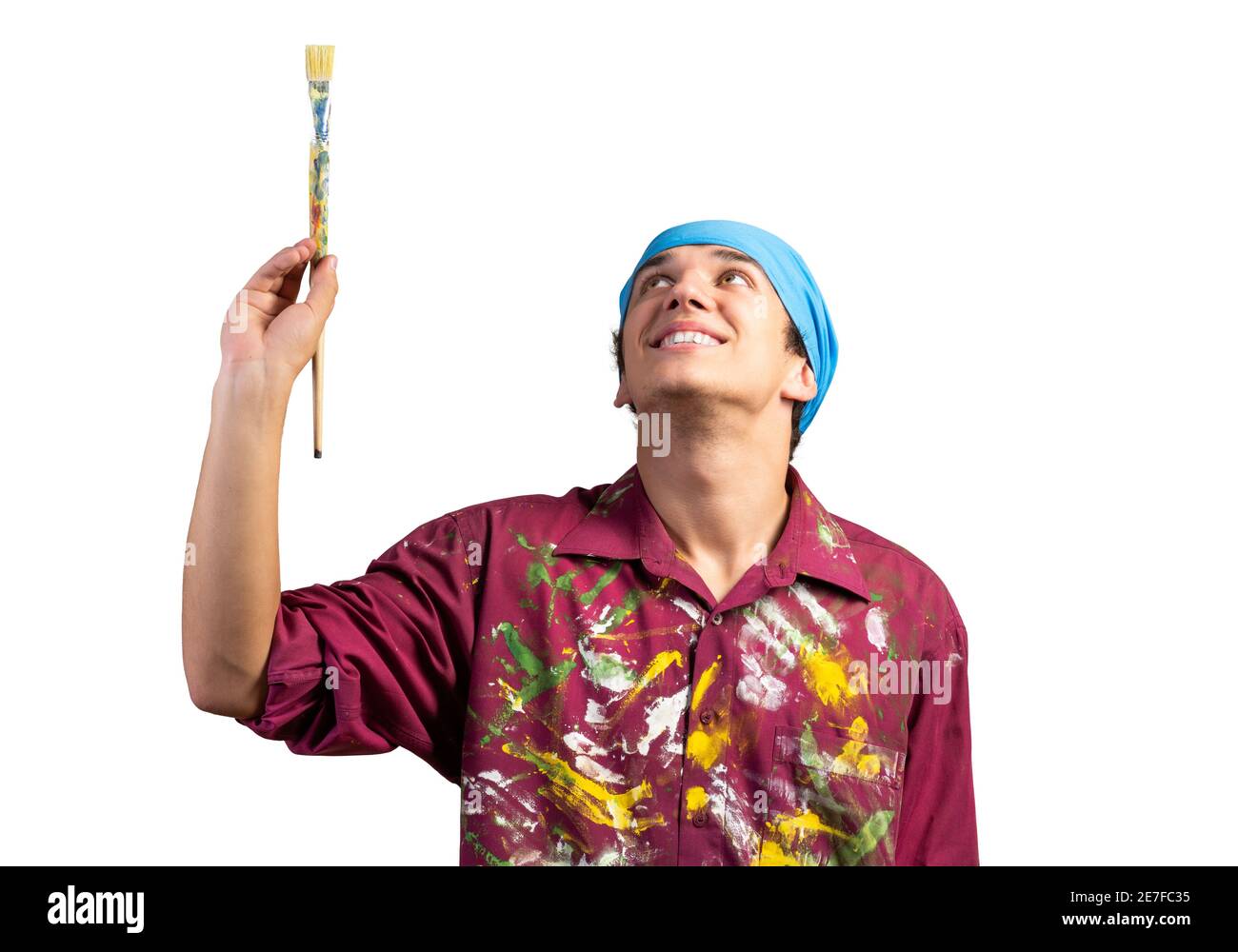 Smiling young painter artist holding paintbrush Stock Photo - Alamy