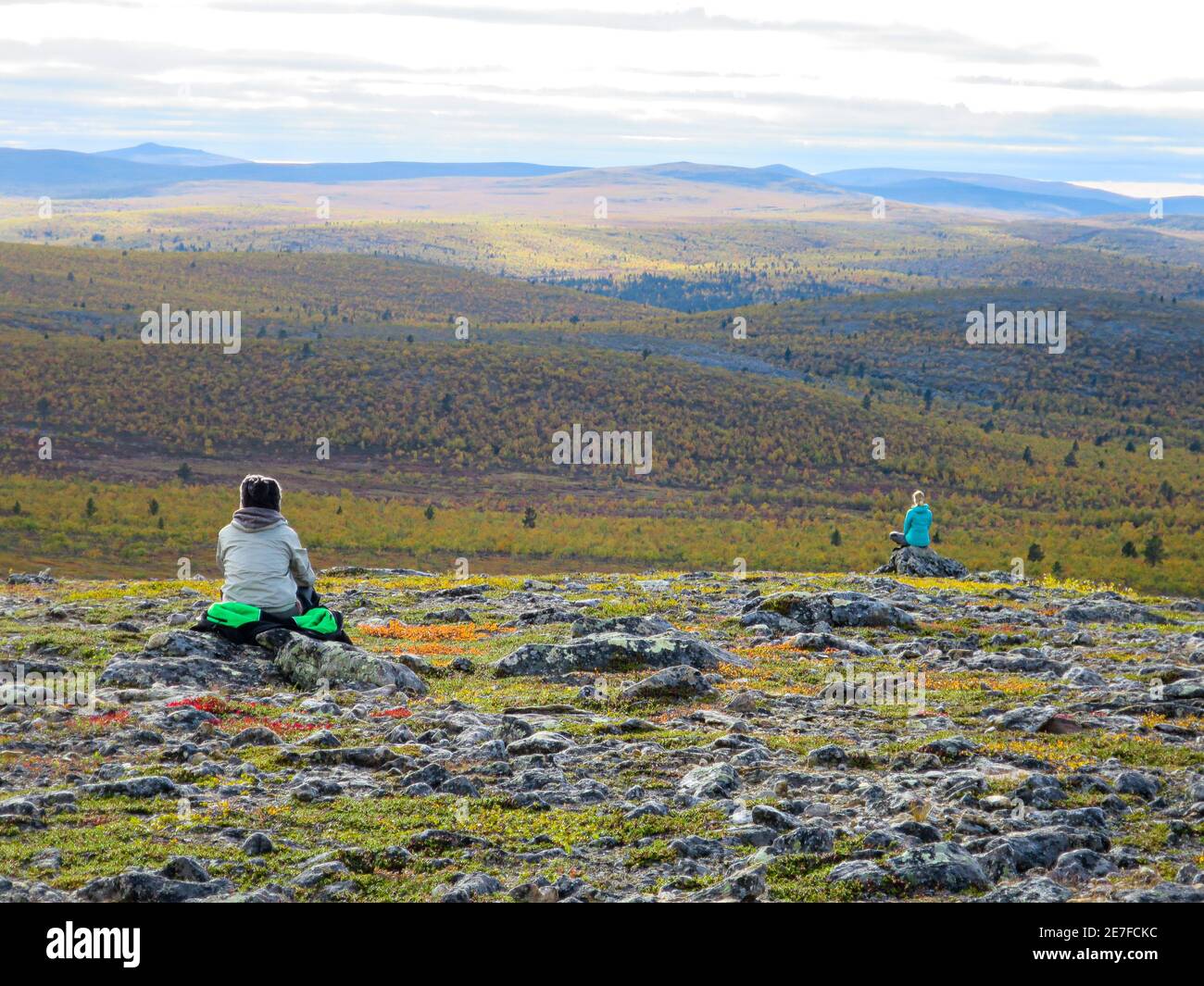 Back view of travelers facing mesmerizing autumn scenery with ...