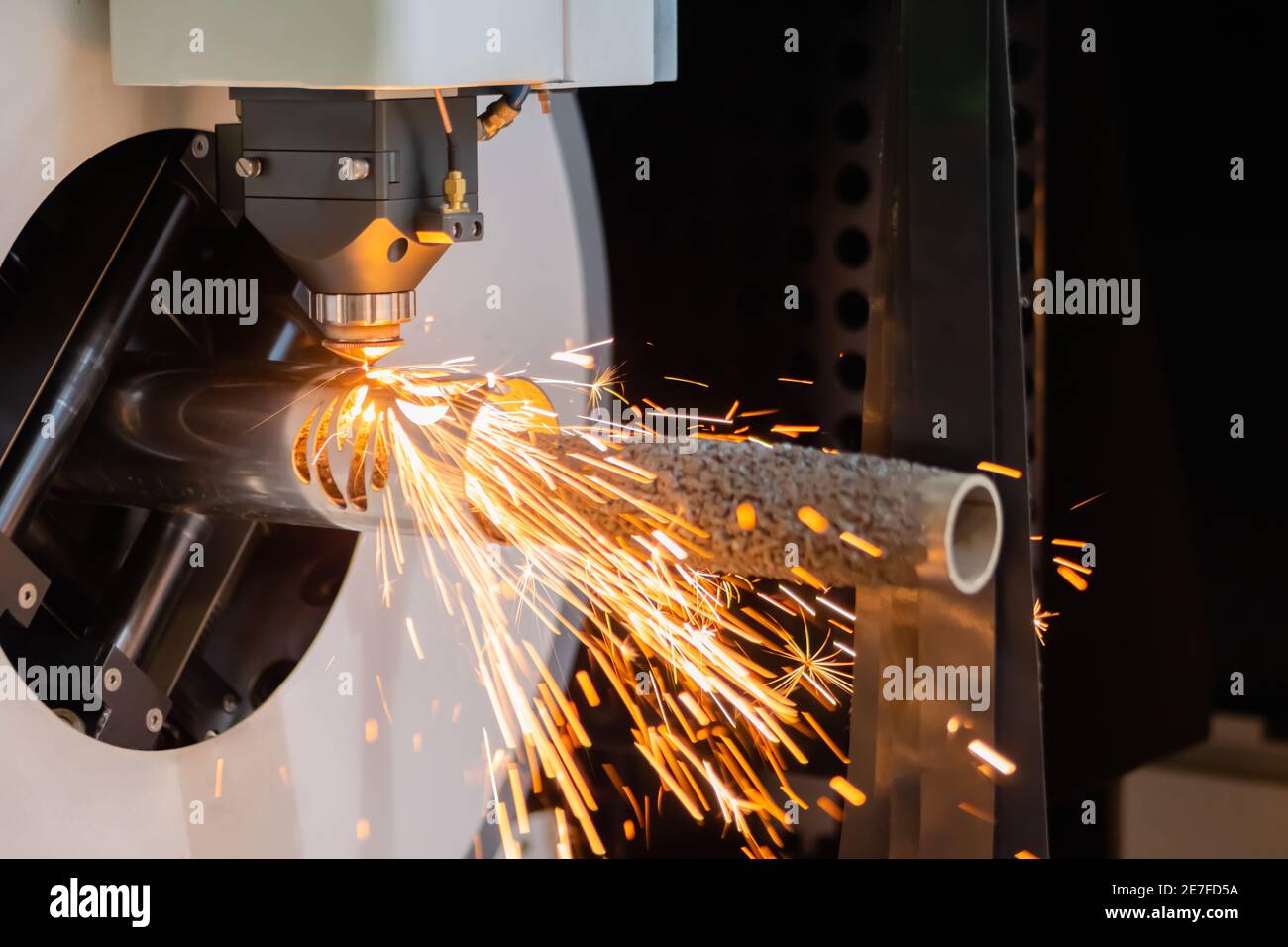 Laser cutting machine working with cylindrical metal workpiece with ...