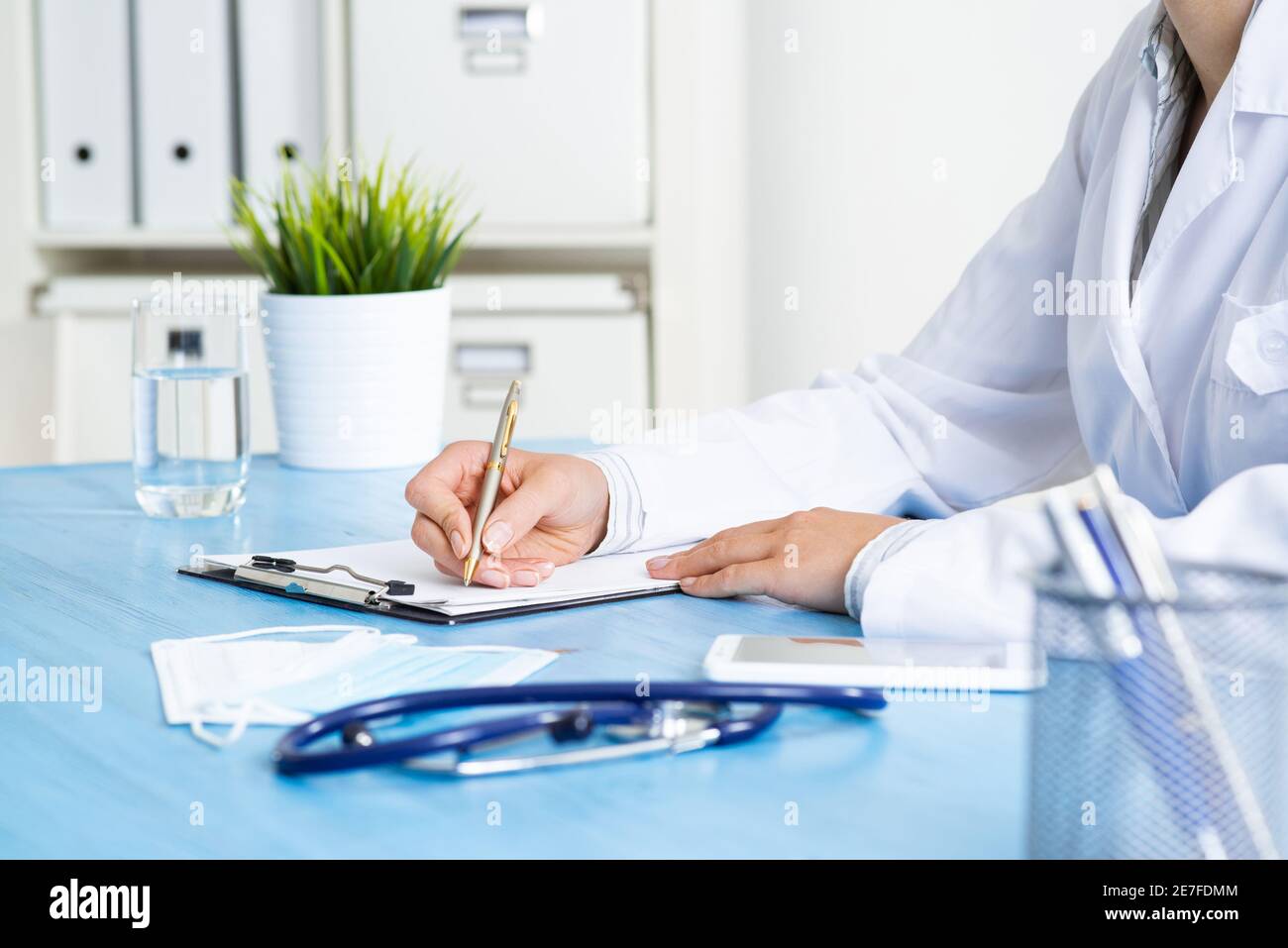 Close-up of female doctor filling medical form Stock Photo - Alamy