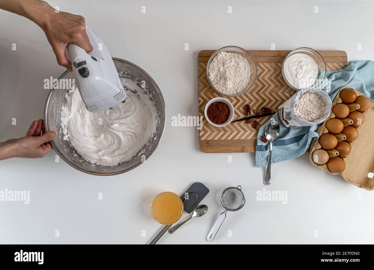 Top view of a person baking a cake with butter, cocoa powder, flour ...