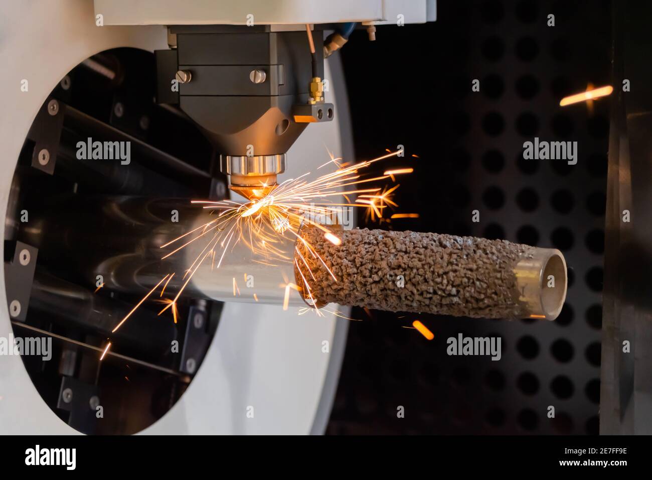 Laser cutting machine working with cylindrical metal workpiece with ...