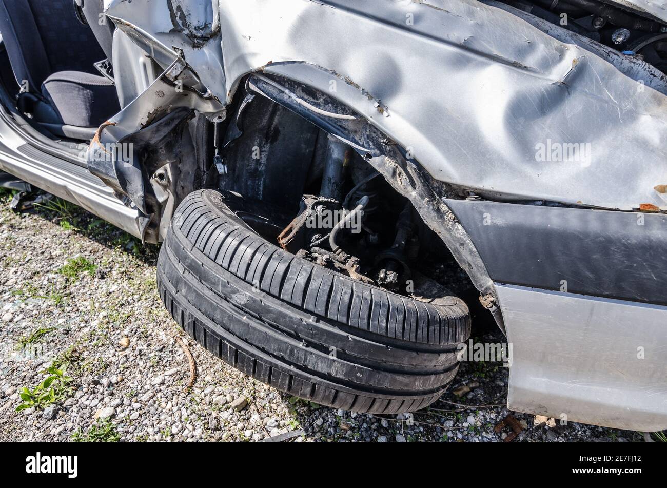 Silver car accident view wheel broken Stock Photo - Alamy