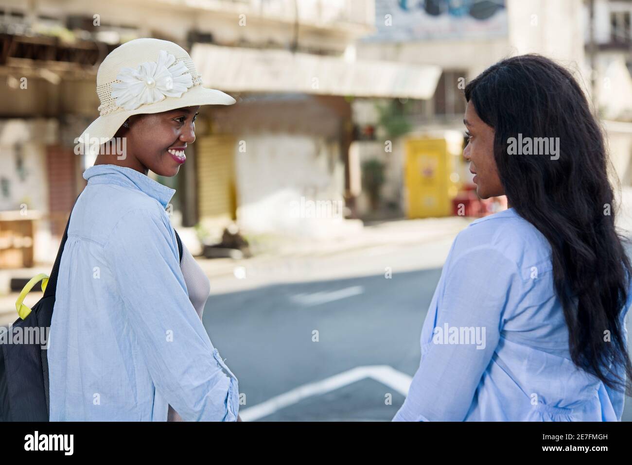 group of happy smiling friends walking on the streets in the city ...