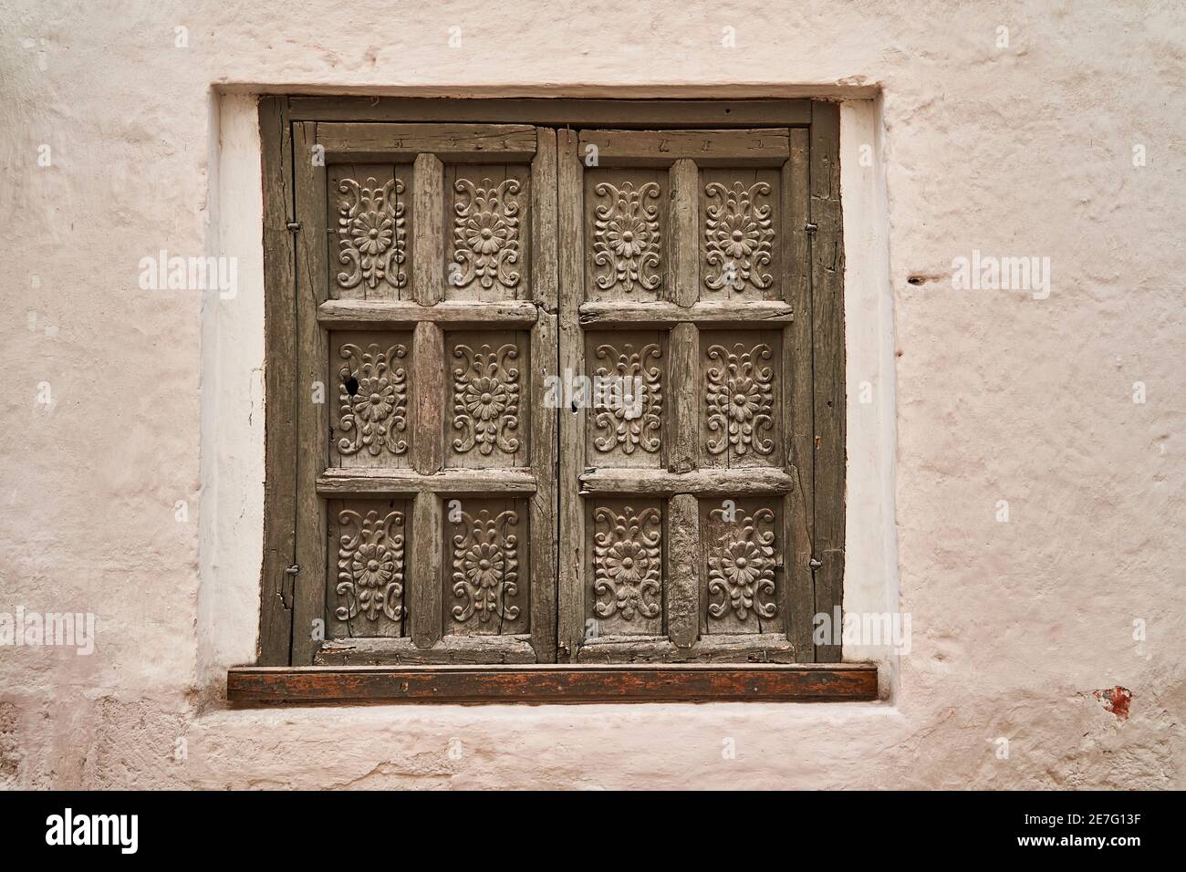 Antique looking wooden window shutters with wood carvings and ornaments ...