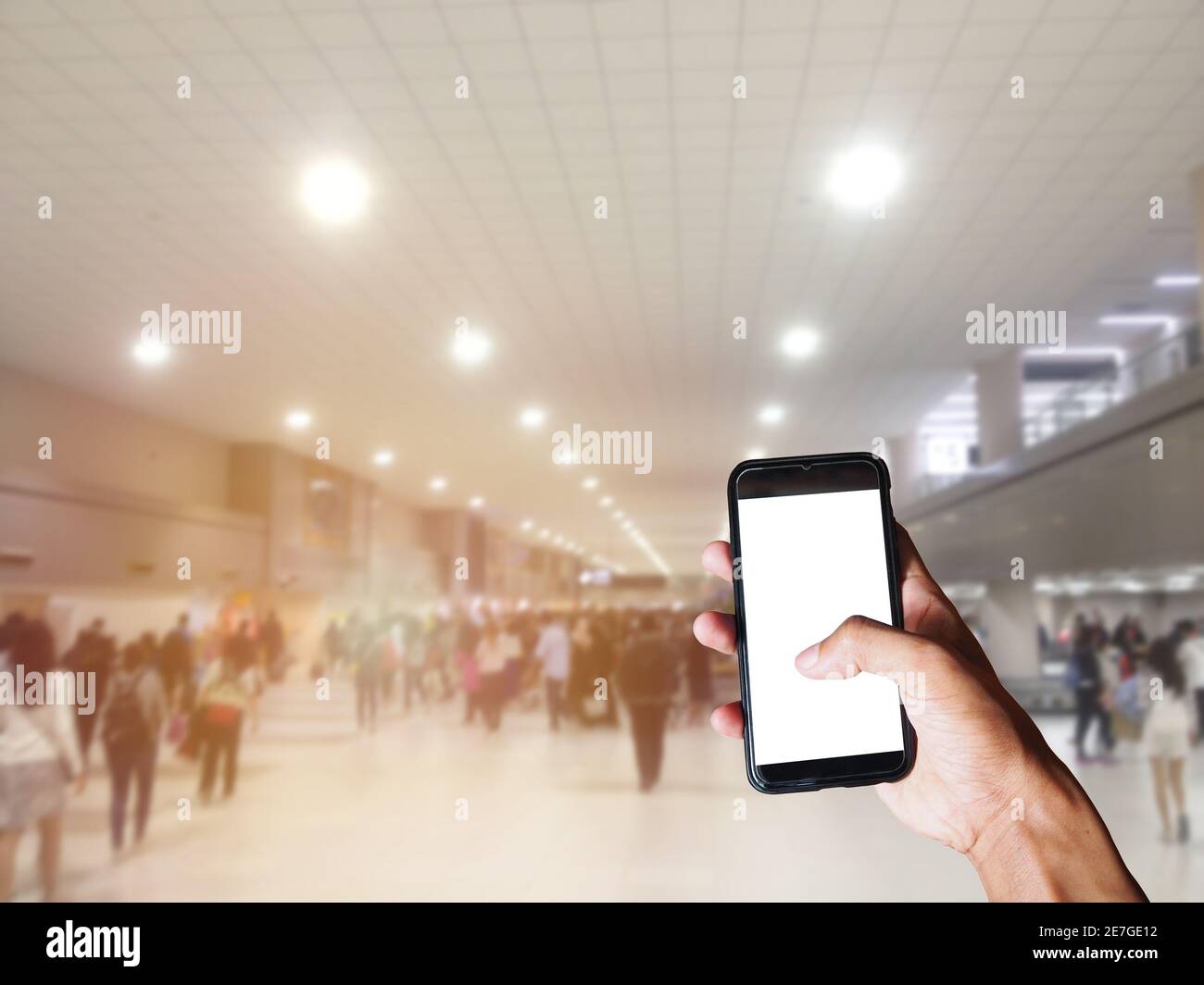 Hand holding black smartphone with blank screen behind many tourist ...