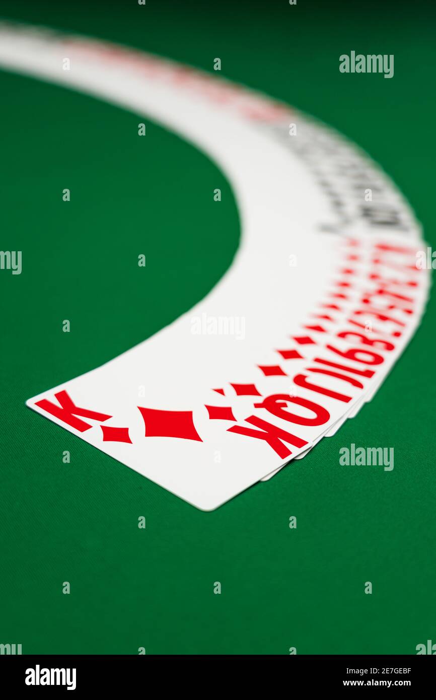 Deck of playing cards spread out on the casino felt Stock Photo - Alamy