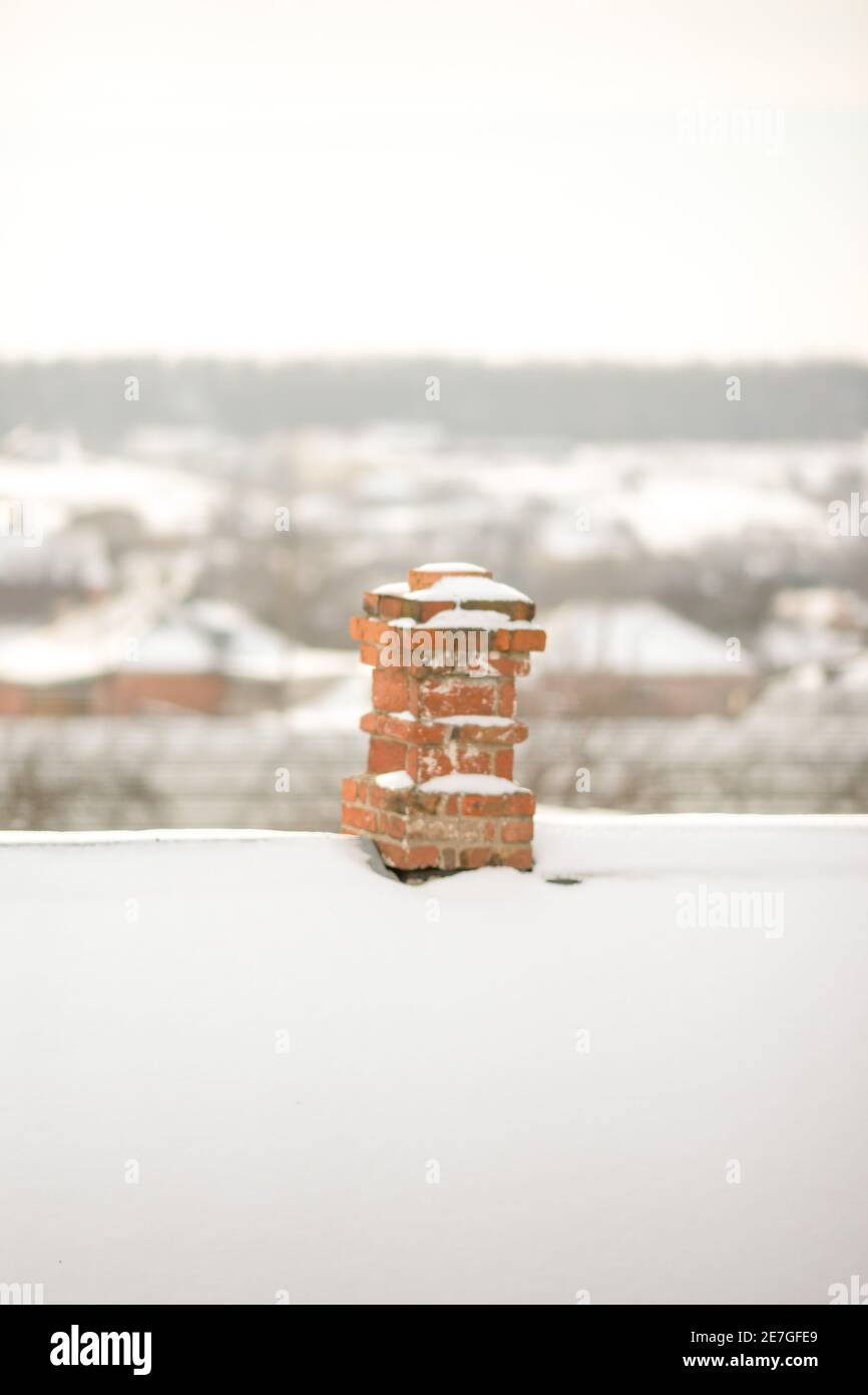 Old red brick chimney with white snow on roof Stock Photo - Alamy