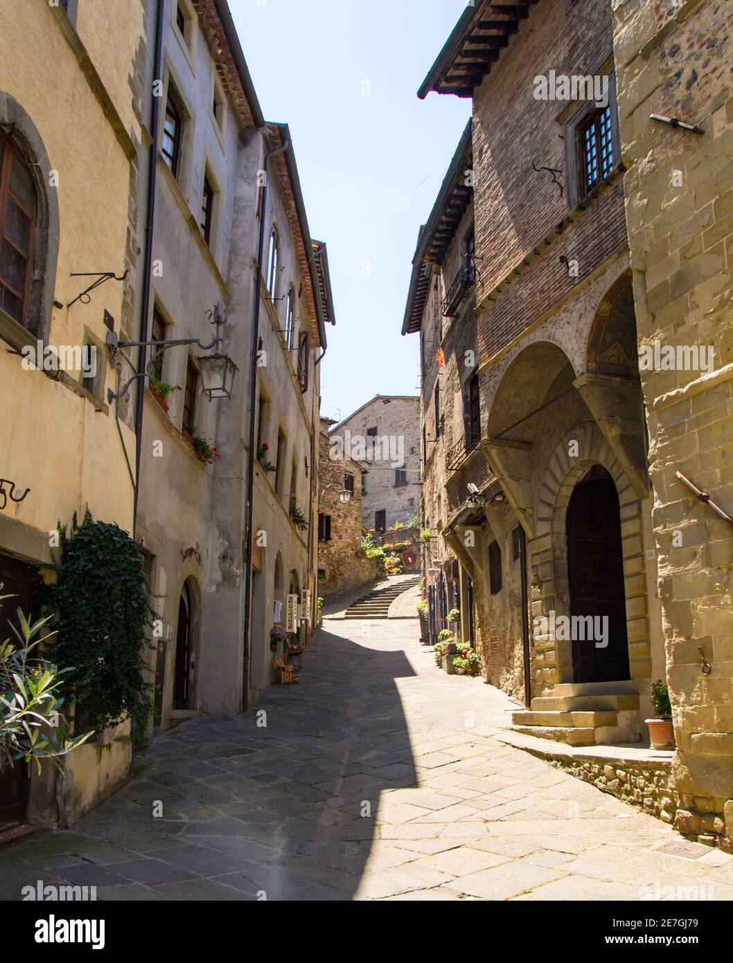 Vertical shot of a pathway surrounded by buildings in Tuscany, Italy ...