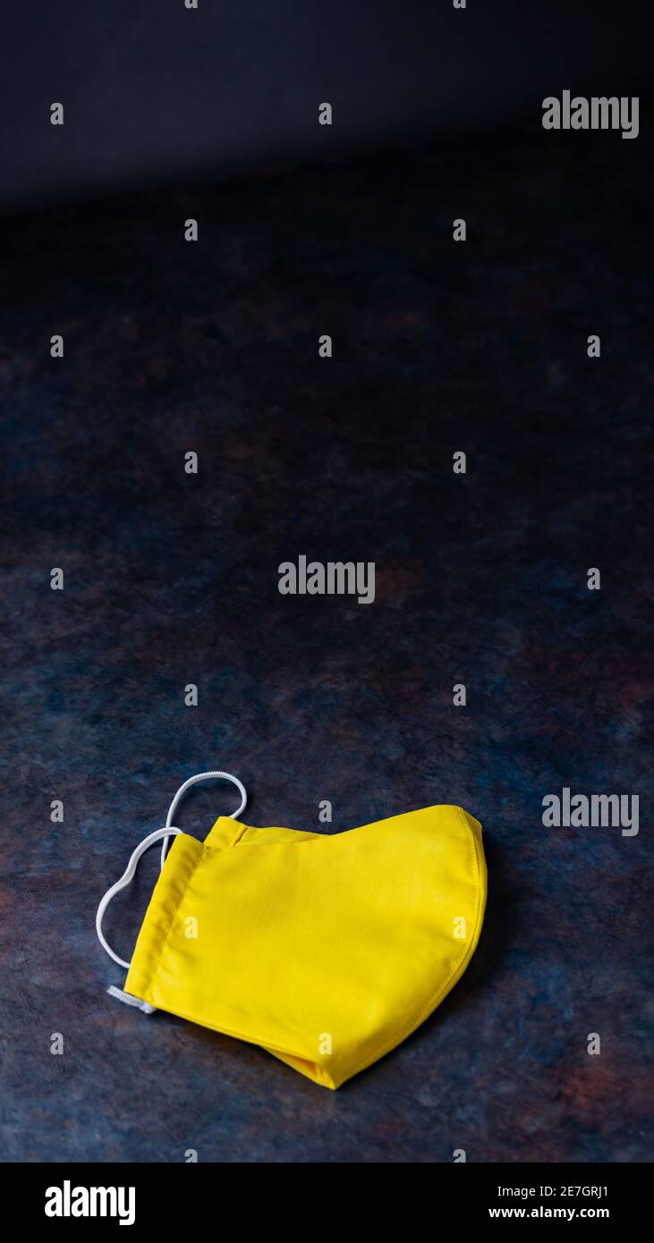 Face protective mask. Reusable antivirus mask made from yellow cotton ...