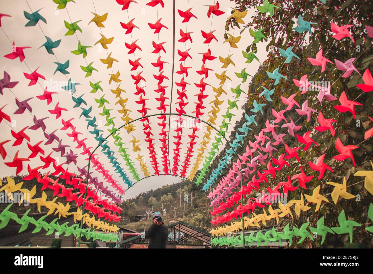 Closeup shot of a photographer taking a picture under a colorful arc ...