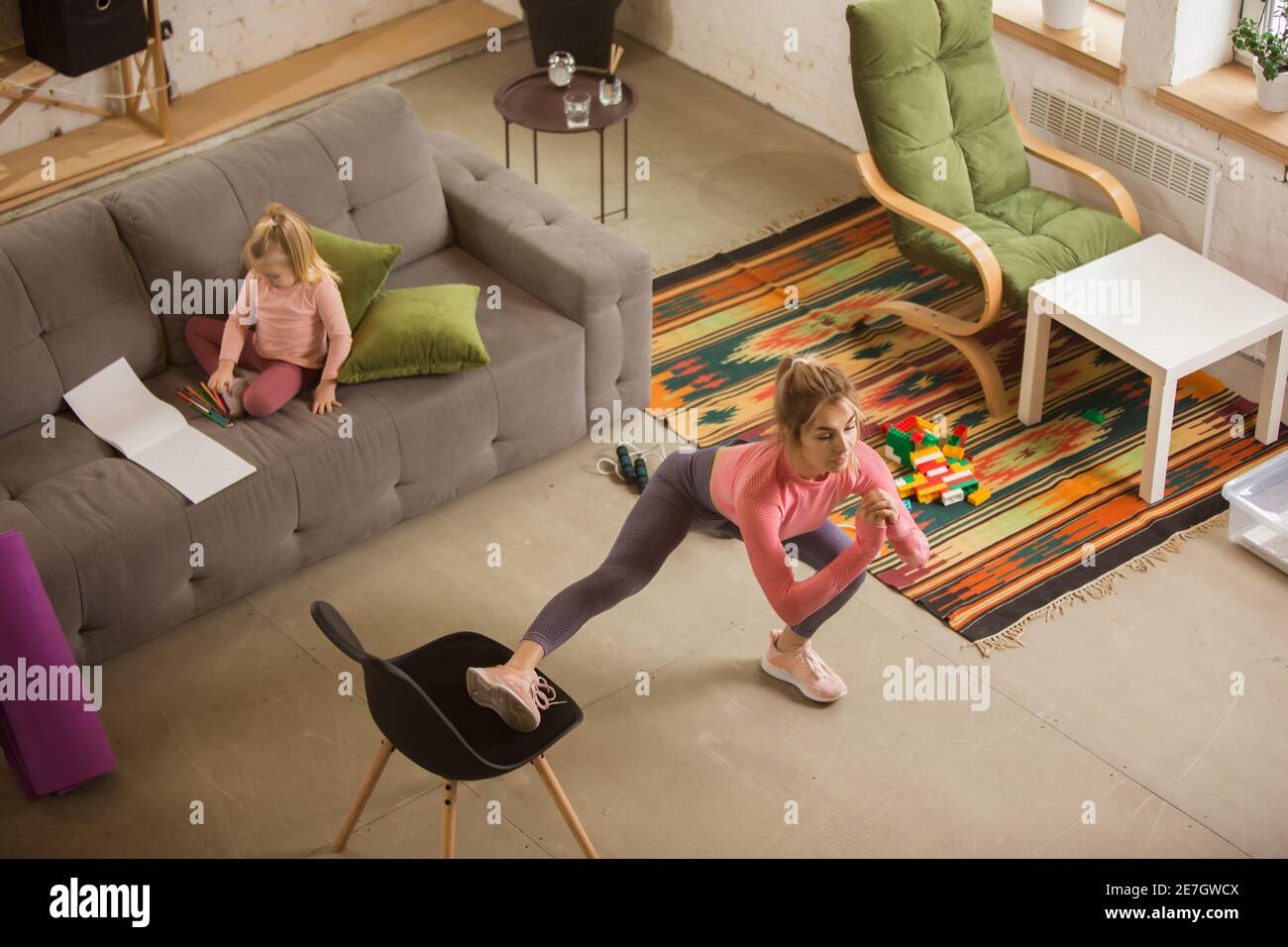 Squats highly concentrated. Young woman exercising fitness, aerobic ...