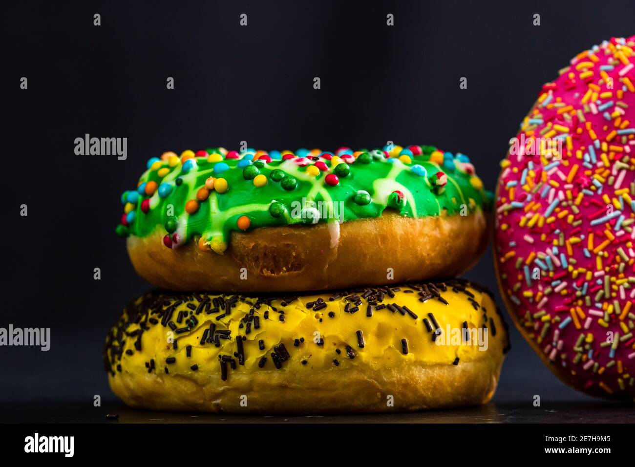 Glazed donuts with sprinkles isolated. Close up of colorful donuts ...