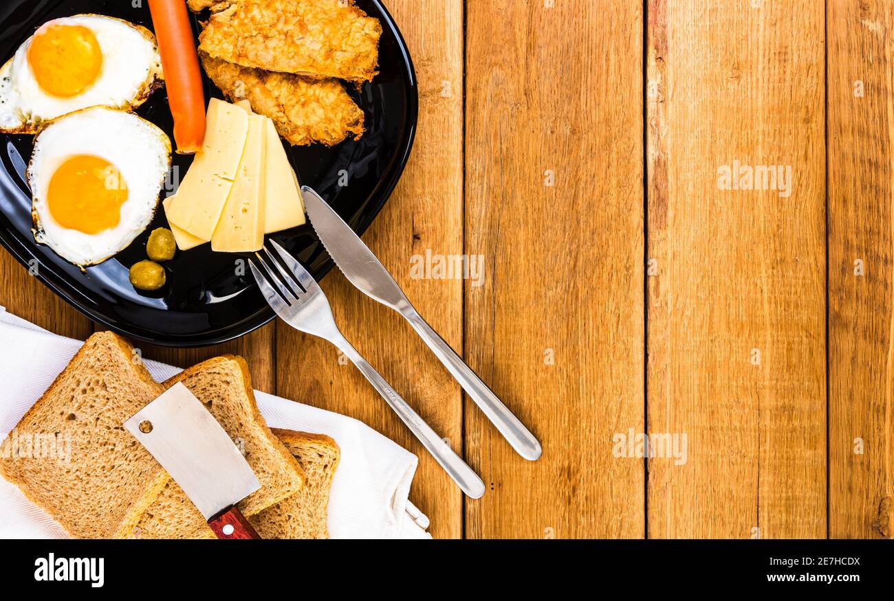 Fried egg, wholegrain toast, cheese, hotdog and cup of coffee for ...