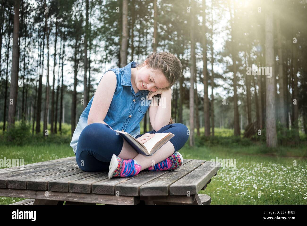 Teenage Pretty Young Girl Sat On Bench In Forest Woods With Legs
