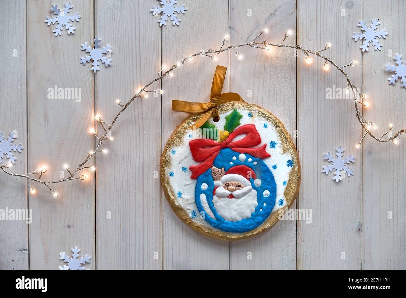 Decorated gingerbread. Cartoon Santa character on bauble with bow and ...