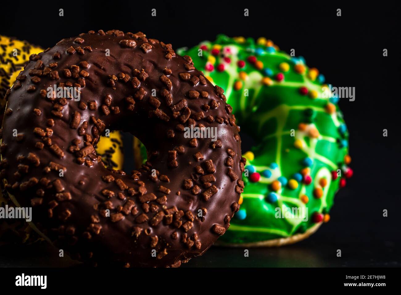 Glazed donuts with sprinkles isolated. Close up of colorful donuts ...