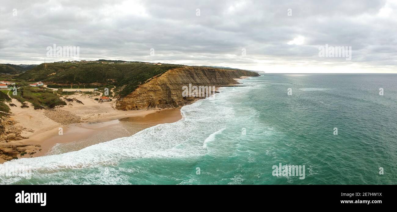 Aerial view of waves on a beautiful sandy ocean beach and cliff ...