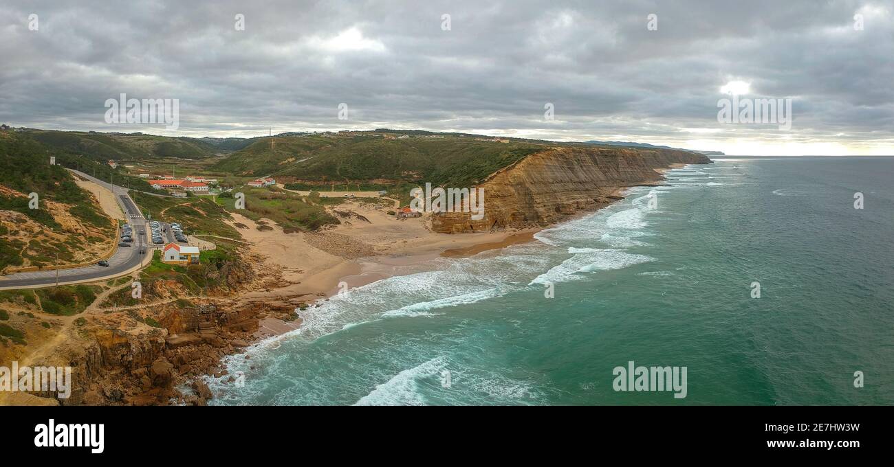 Aerial view of waves on a beautiful sandy ocean beach and cliff ...