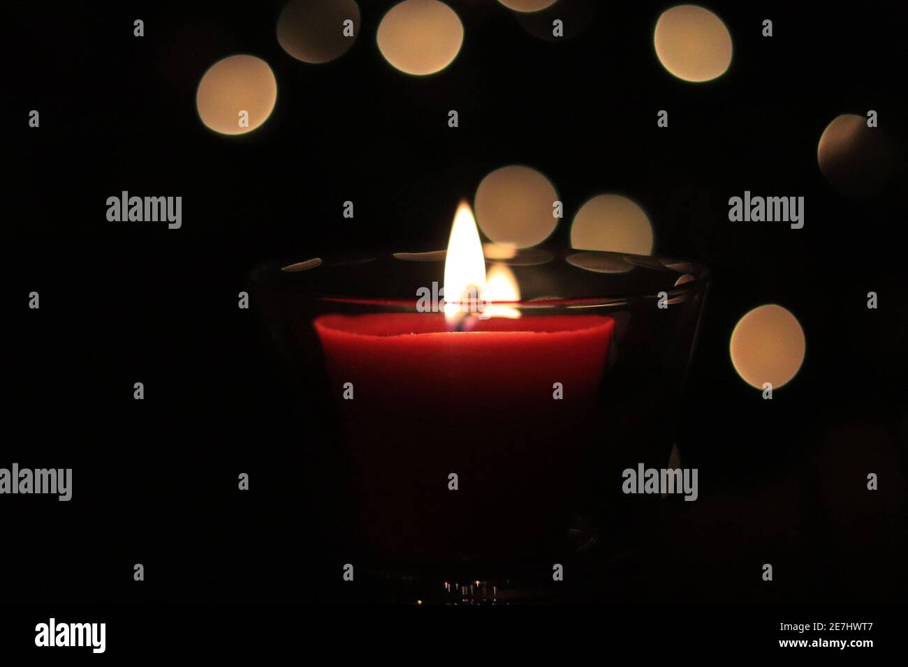 red candle flame at night with lights in background Stock Photo - Alamy