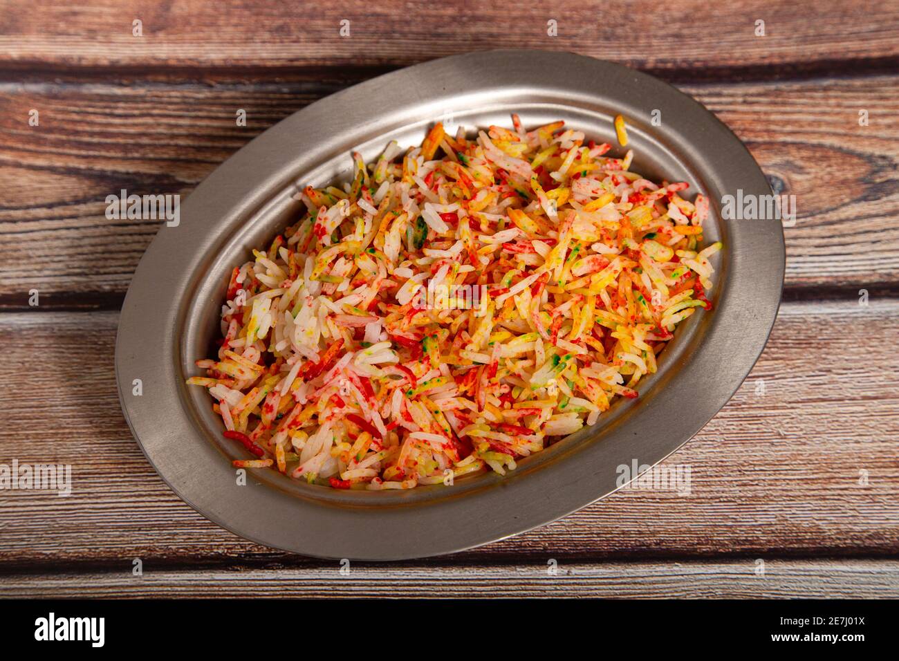 Basmati rice with spices and vegetables isolated on wooden background ...