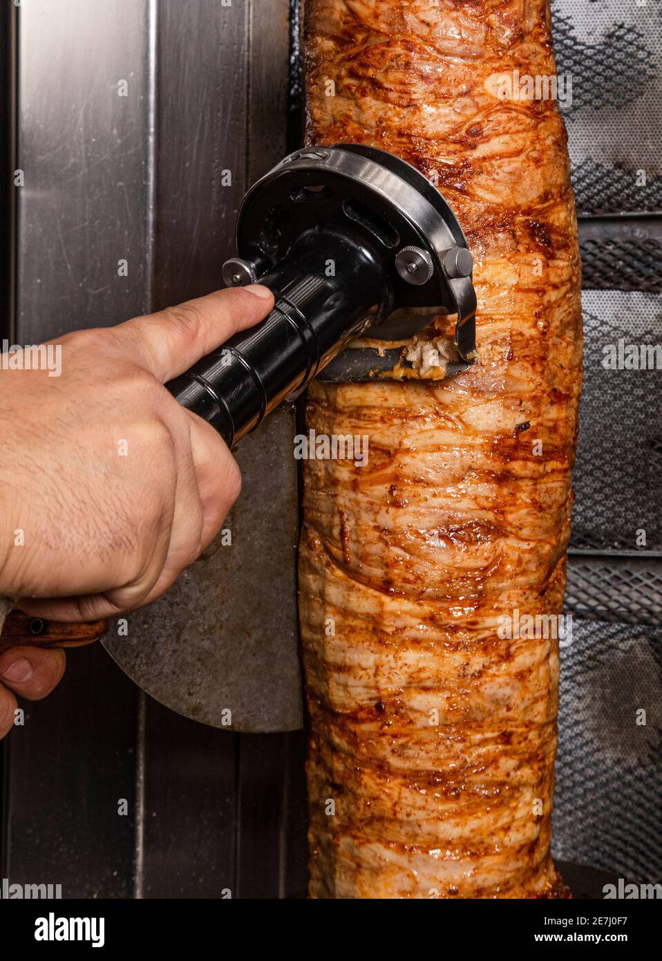 Closeup of Kebab and a hand, slicing meat Stock Photo - Alamy