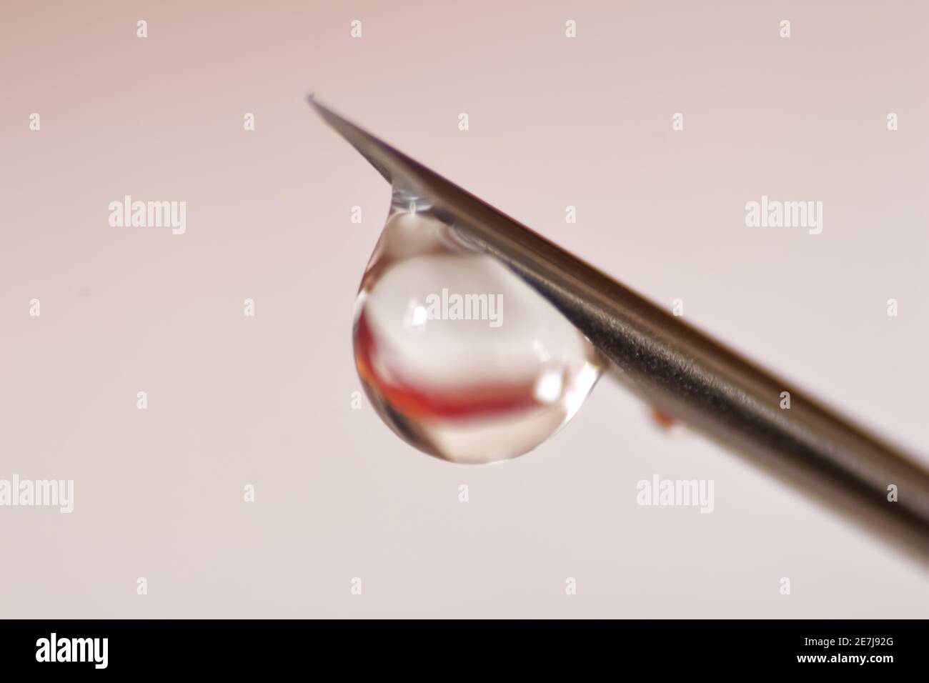 Macro shot of the water drop standing on the tip of the syringe Stock ...