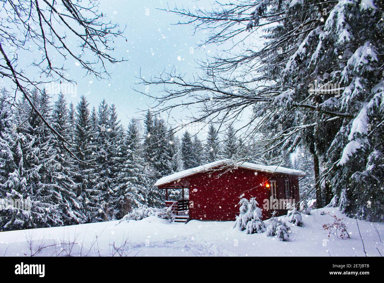red wooden cabin in winter forest with snowfall background Stock Photo ...