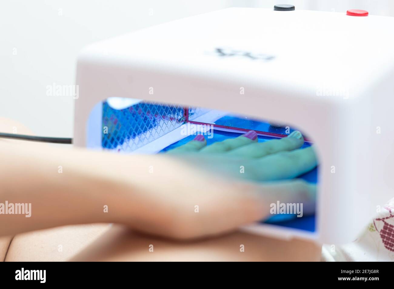 Female hand in a nail dryer with LED lamps Stock Photo - Alamy