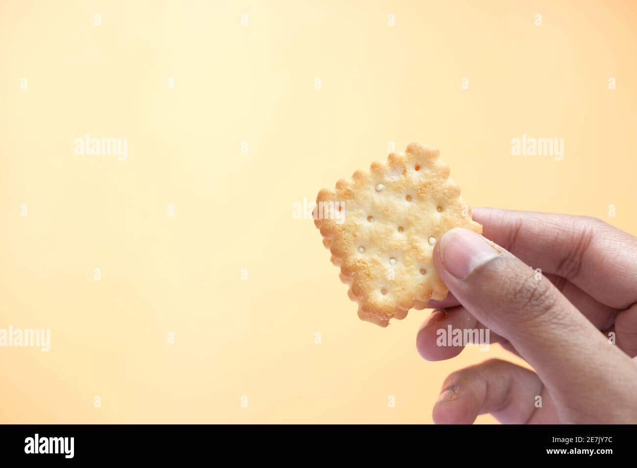 hand holding sweet cookies on color background Stock Photo - Alamy