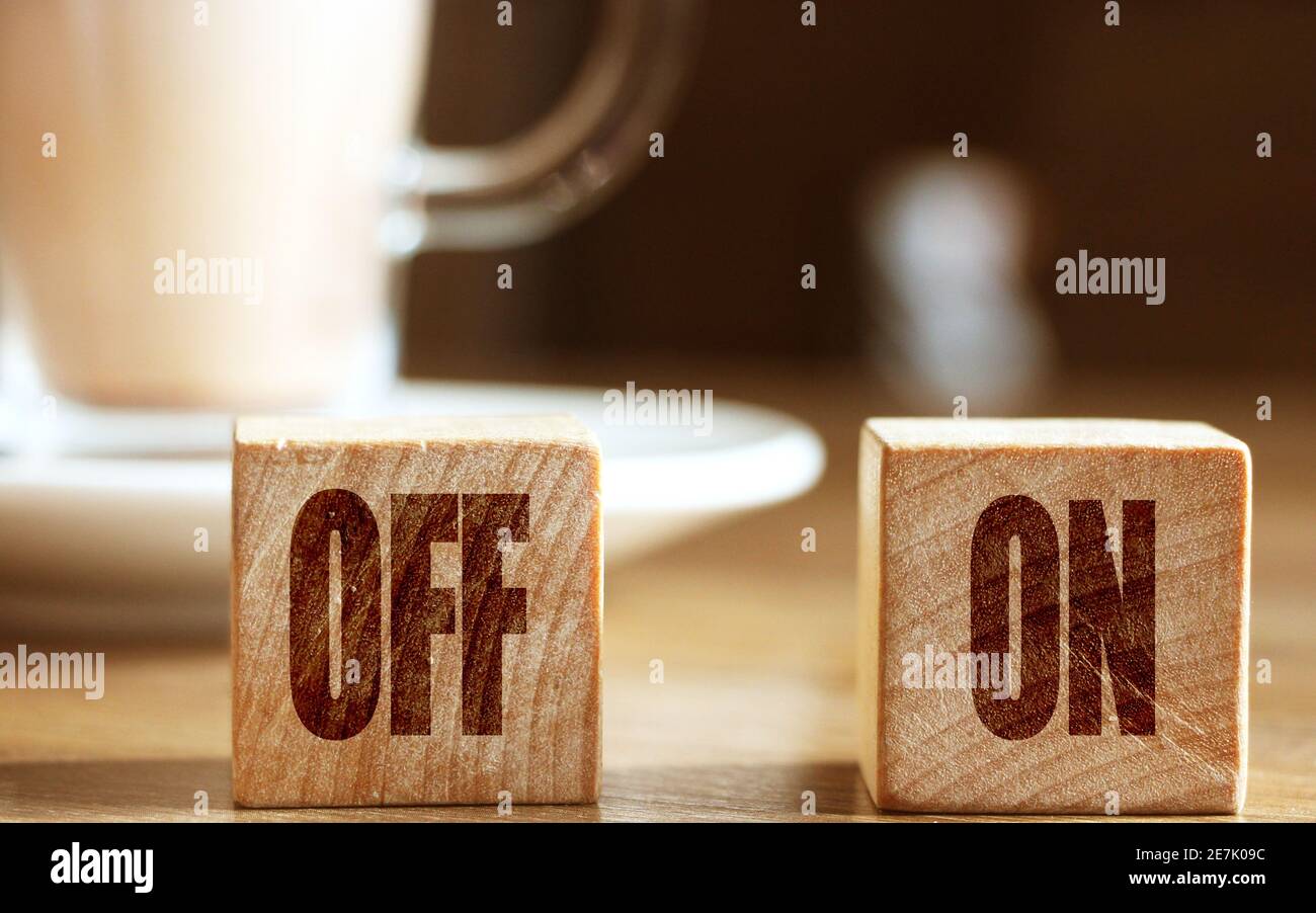 Two wooden blocks with inscription OFF and ON and cup of cacao ...
