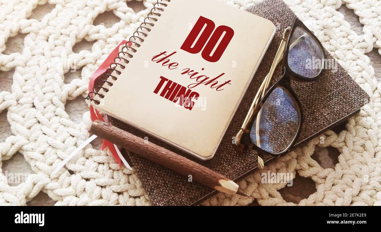 Text Do The Right Things words on the cover of notebook , eyeglasses ...