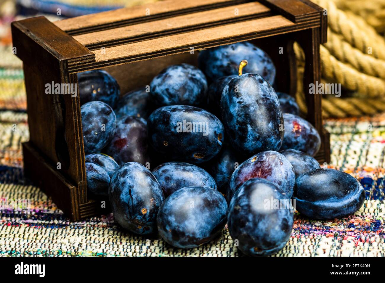 Ripe blue plums in a wooden crate in a rustic composition Stock Photo ...