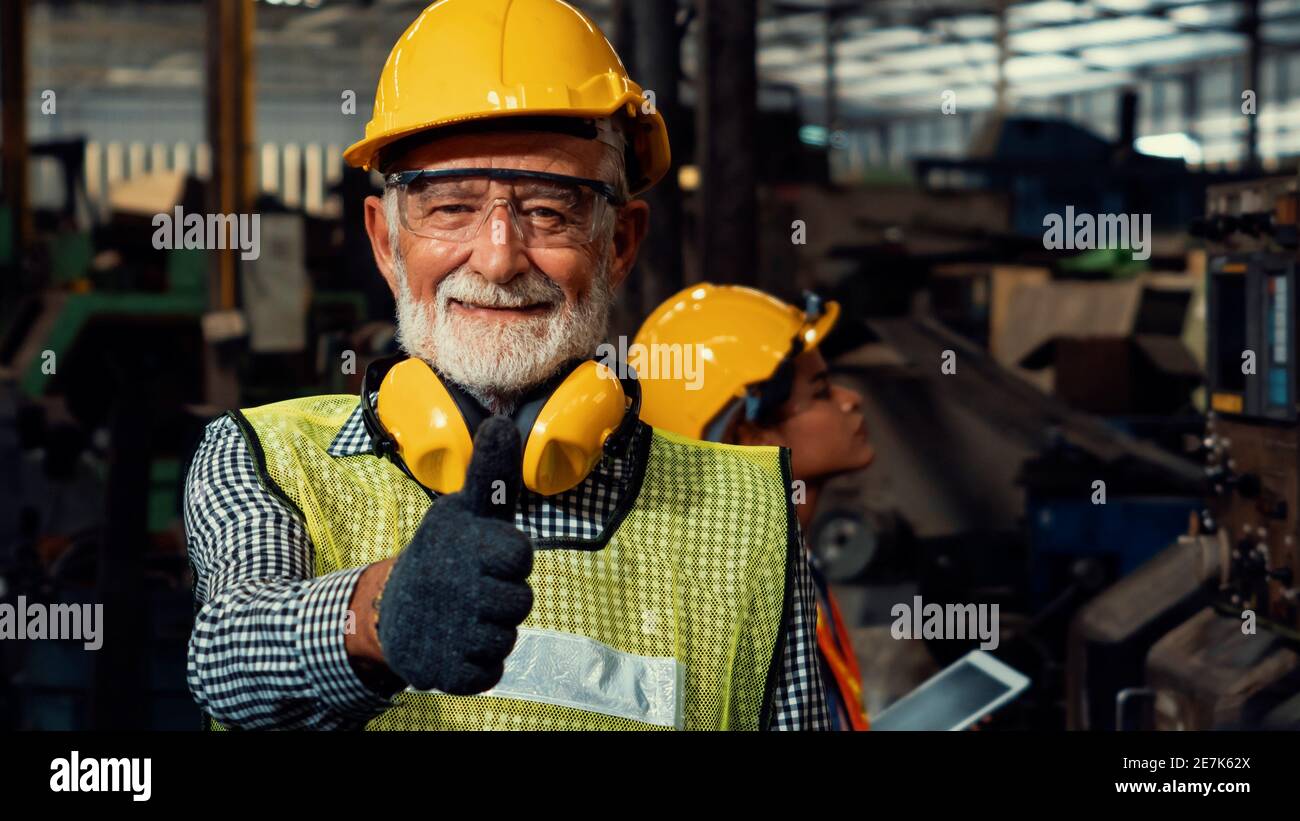 Senior skillful factory worker or engineer close up portrait in factory ...
